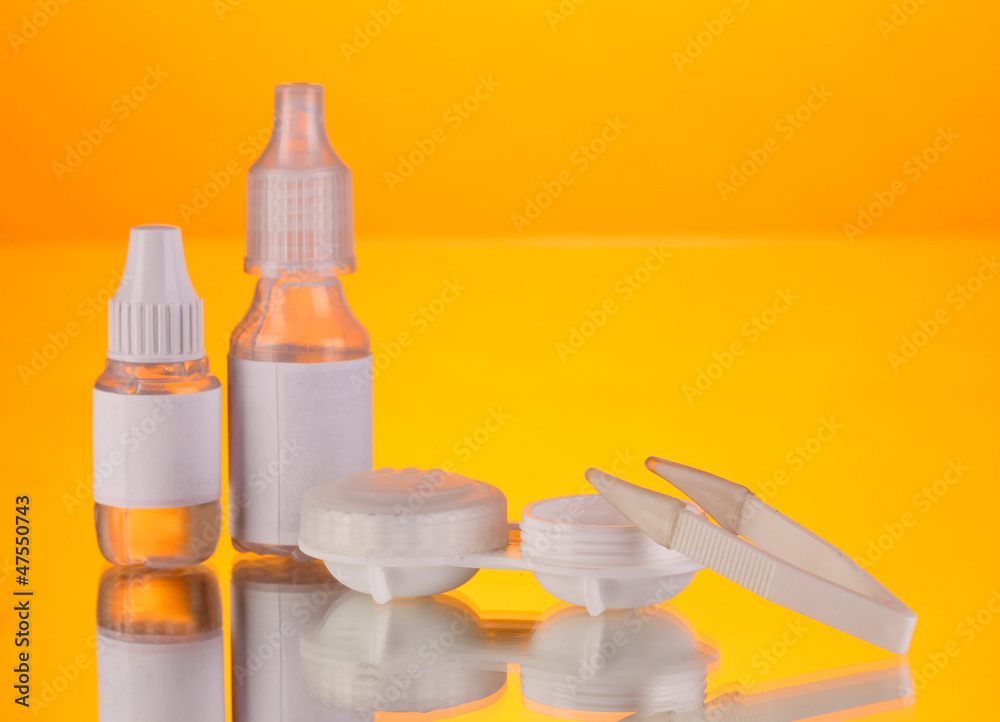 Eye drops and lenses on orange background Stock Photo | Adobe Stock
