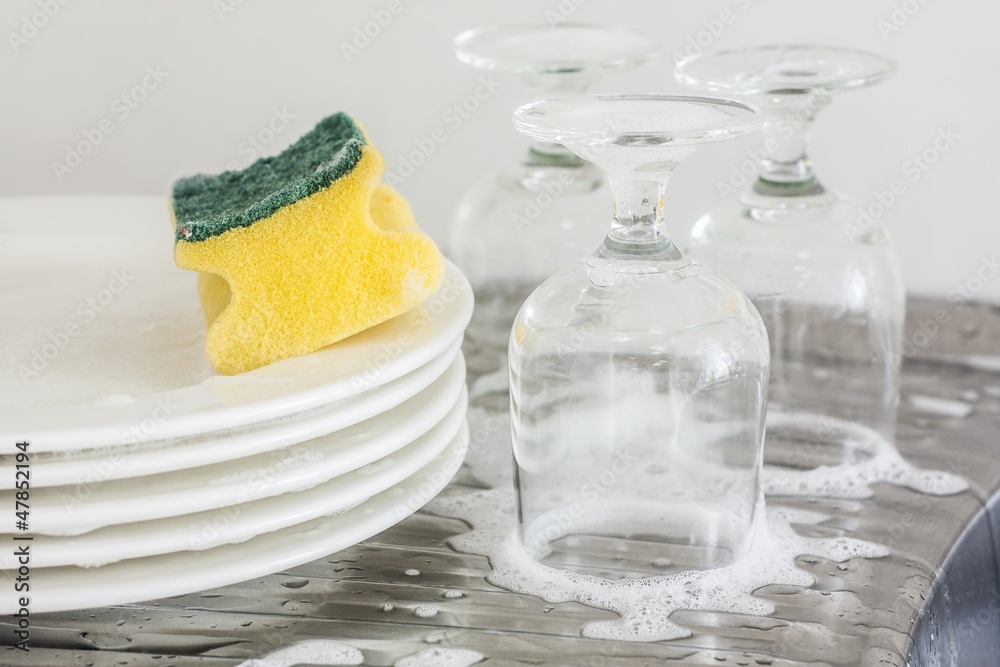 Washing glasses and plates with detergent and water Stock Photo | Adobe ...