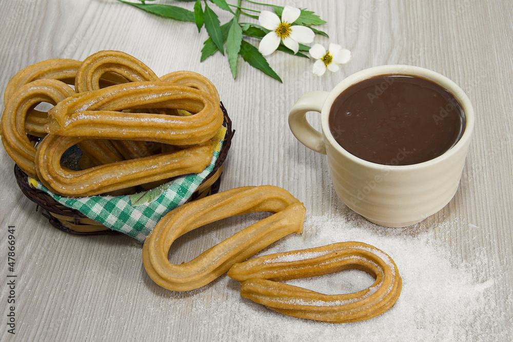 Churros de lazo, madrileños, con chocolate. foto de Stock | Adobe Stock