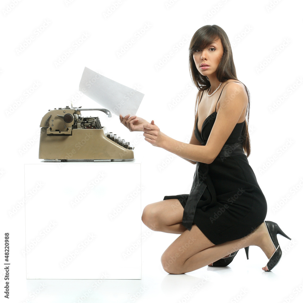 Beautiful attractive girl typing on a typewriter Stock-Foto | Adobe Stock