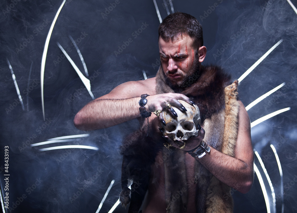 Scary man in a bear coat with scar and a human skull Stock Photo ...