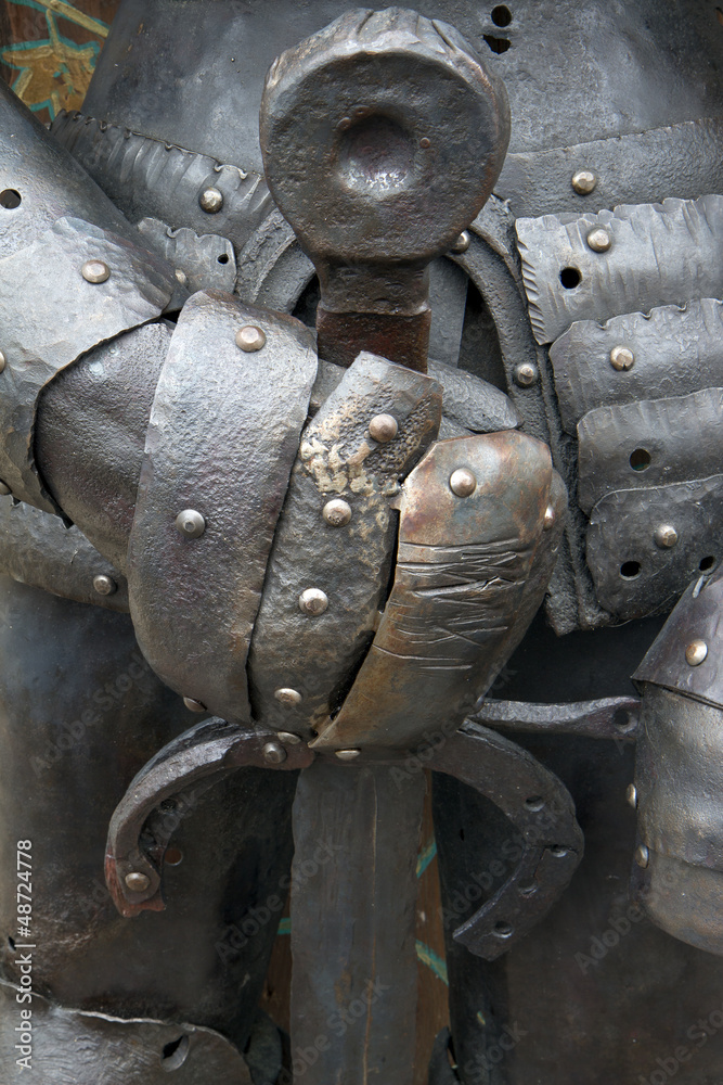Medieval iron knight holding metal sword Stock Photo | Adobe Stock