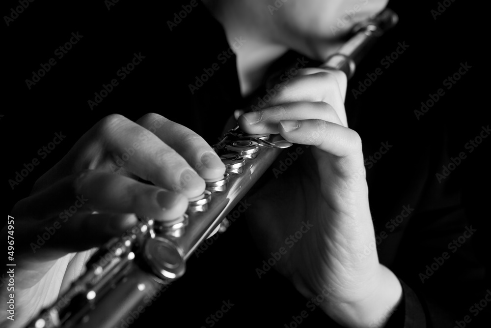 professional flutist musician playing flute on black background Stock ...
