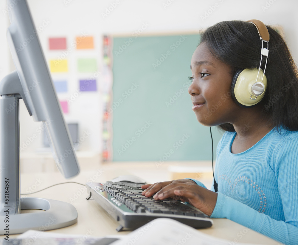 Black student using computer in classroom Stock Photo | Adobe Stock