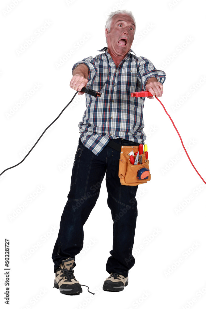 Man getting an electric shock from jump leads Stock Photo | Adobe Stock