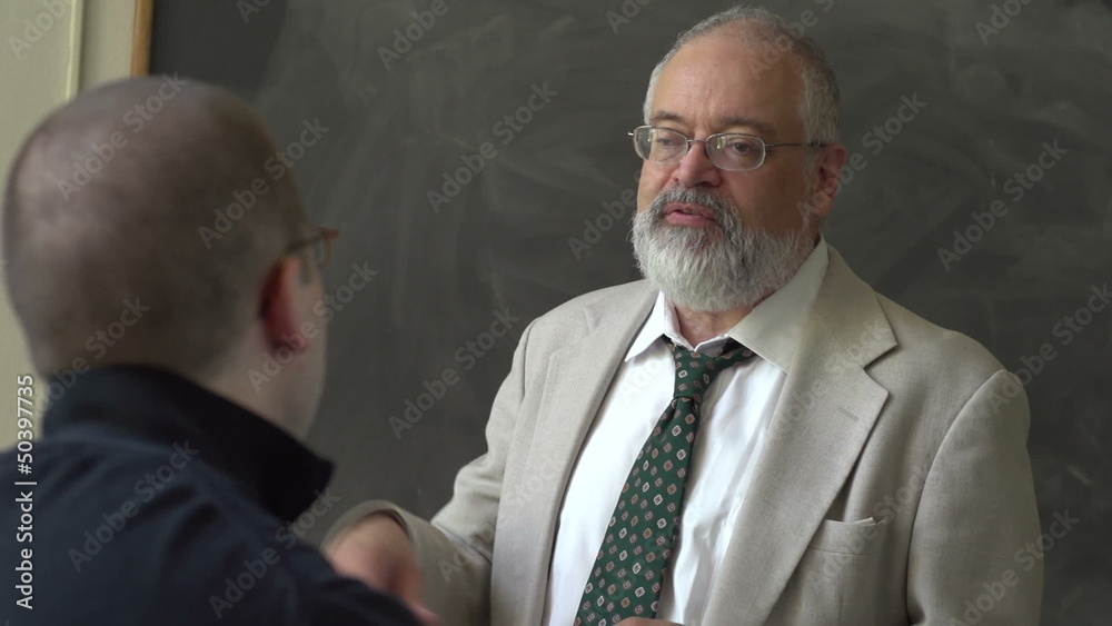 Professor and student talking in a classroom Stock-Video | Adobe Stock
