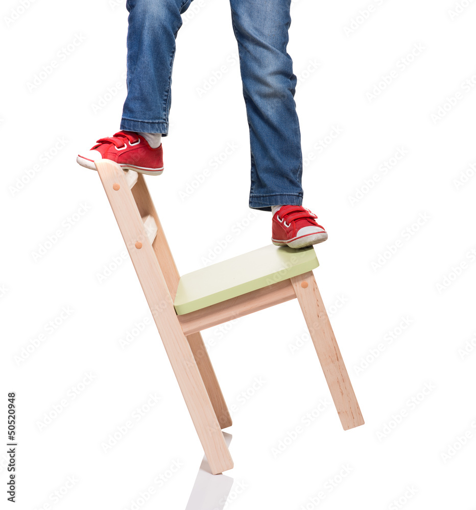 child's feet standing on the little chair Stock Photo | Adobe Stock