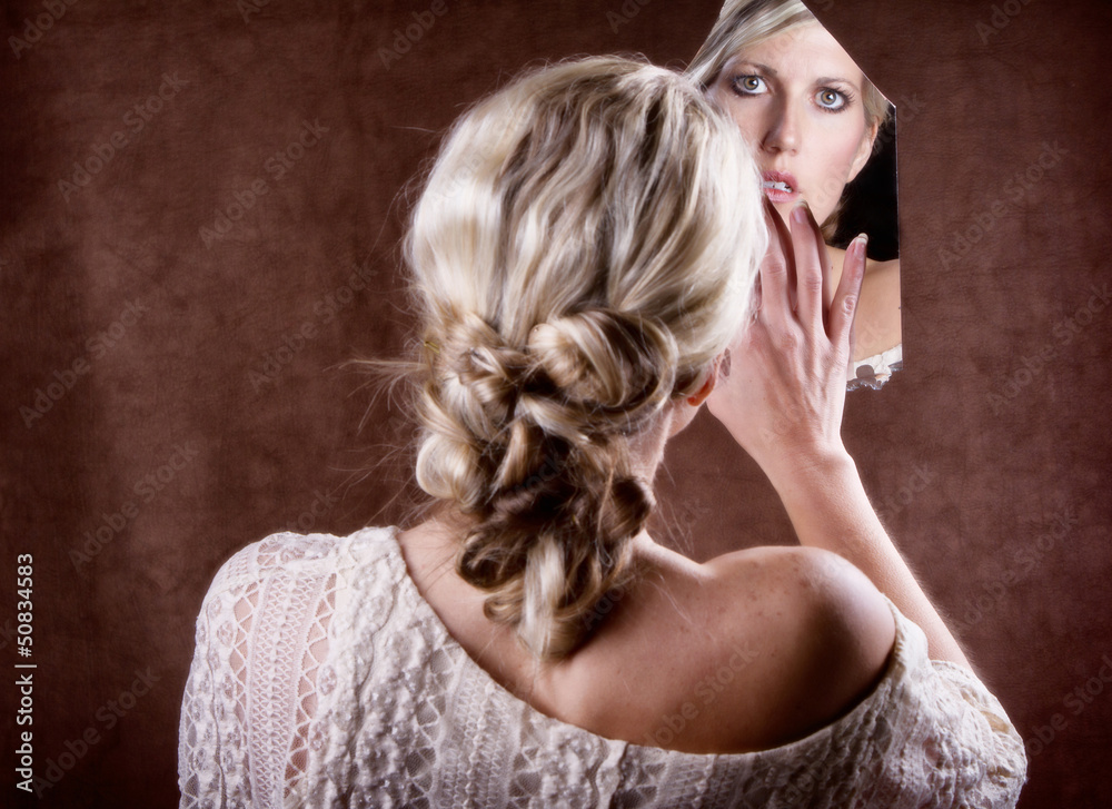 woman looking into a broken mirror Stock Photo | Adobe Stock