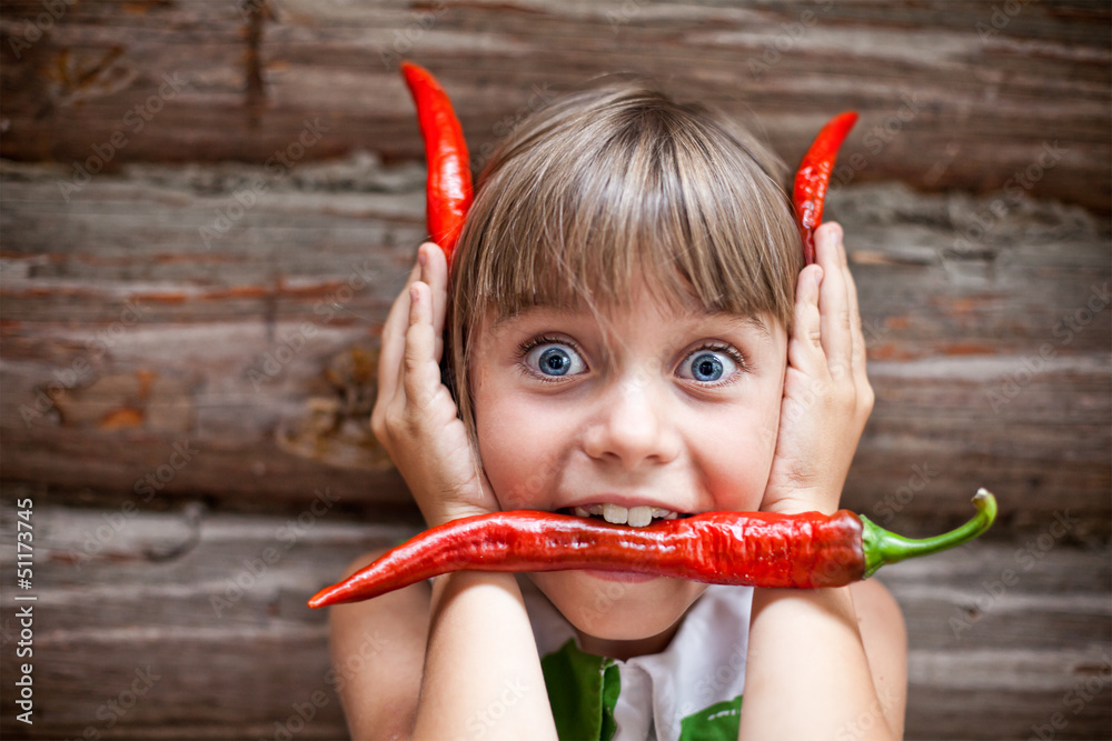 Girl with a red hot chili pepper in her mouth show devil horns Stock ...