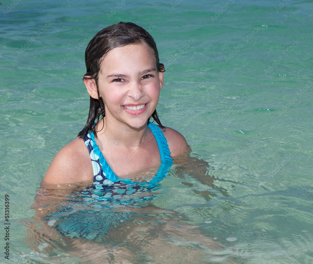 Happy tween girl in the clear ocean Stock Photo | Adobe Stock