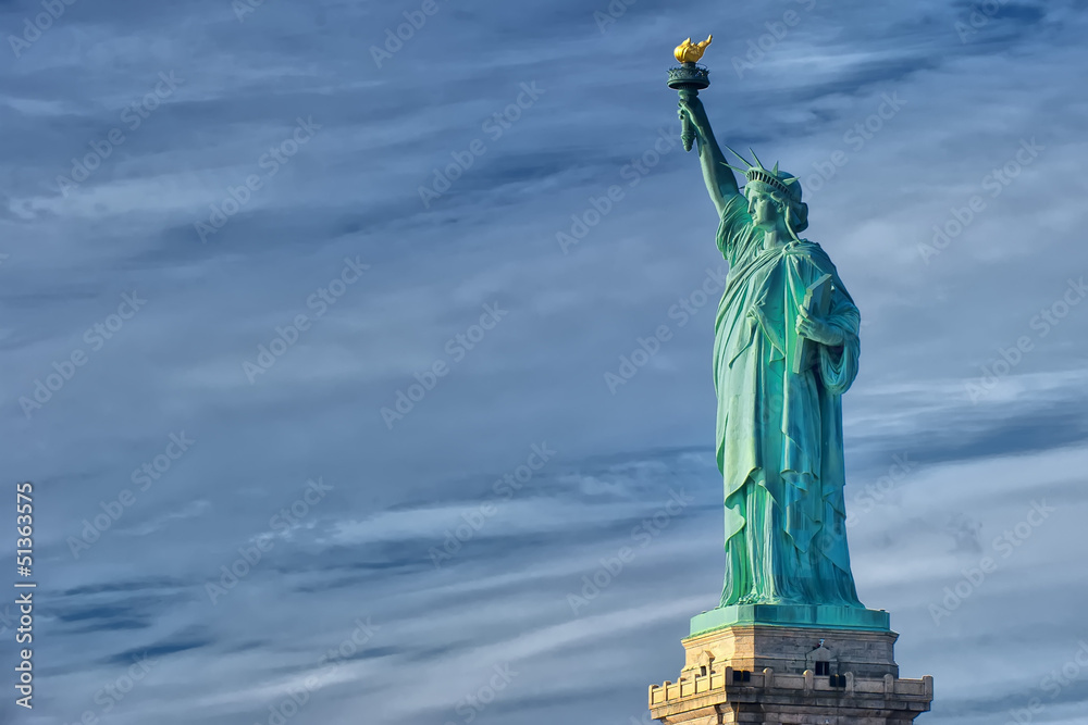Statue of liberty isolated in blue cloudy background Stock Photo ...