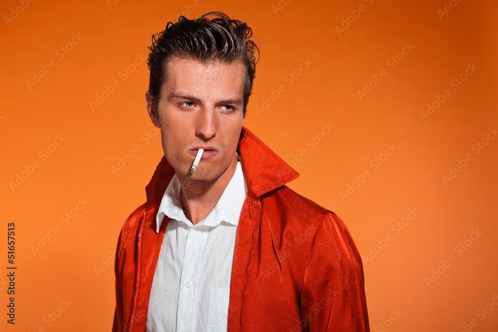 Vintage fashion fifties man smoking cigarette. Rebel look. Stock Photo ...