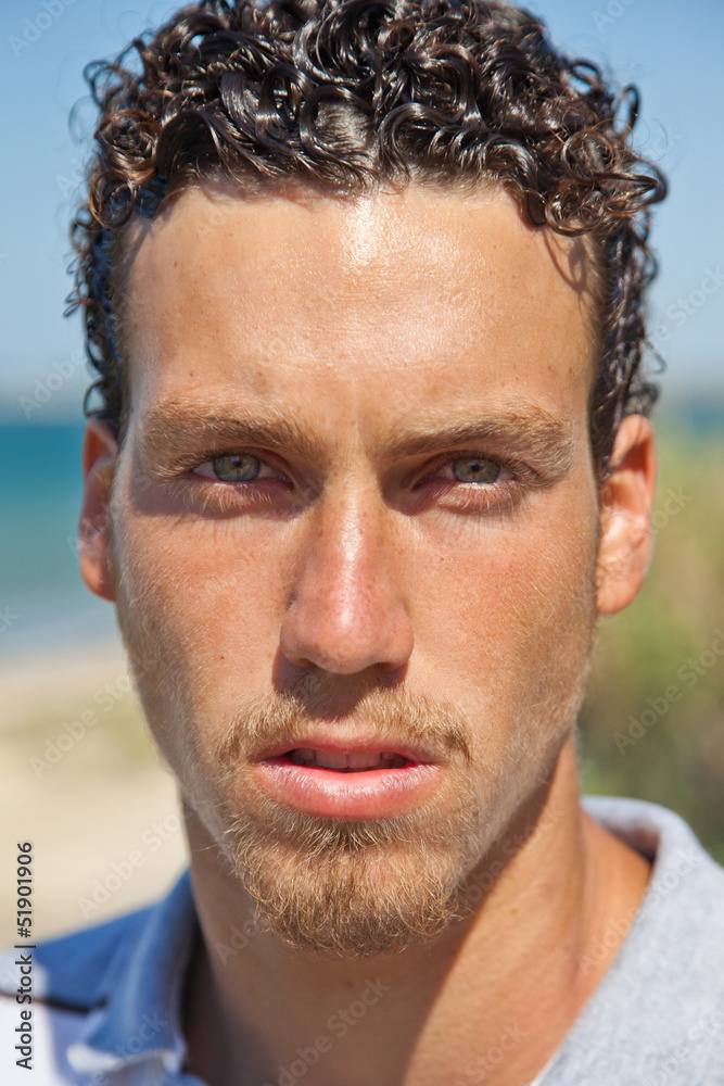 Portrait of a handsome young mediterranean man with curly hair Stock ...