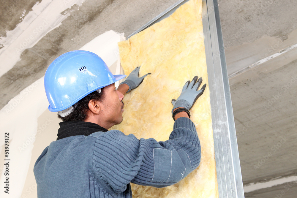 Man fitting wall insulation Stock Photo | Adobe Stock