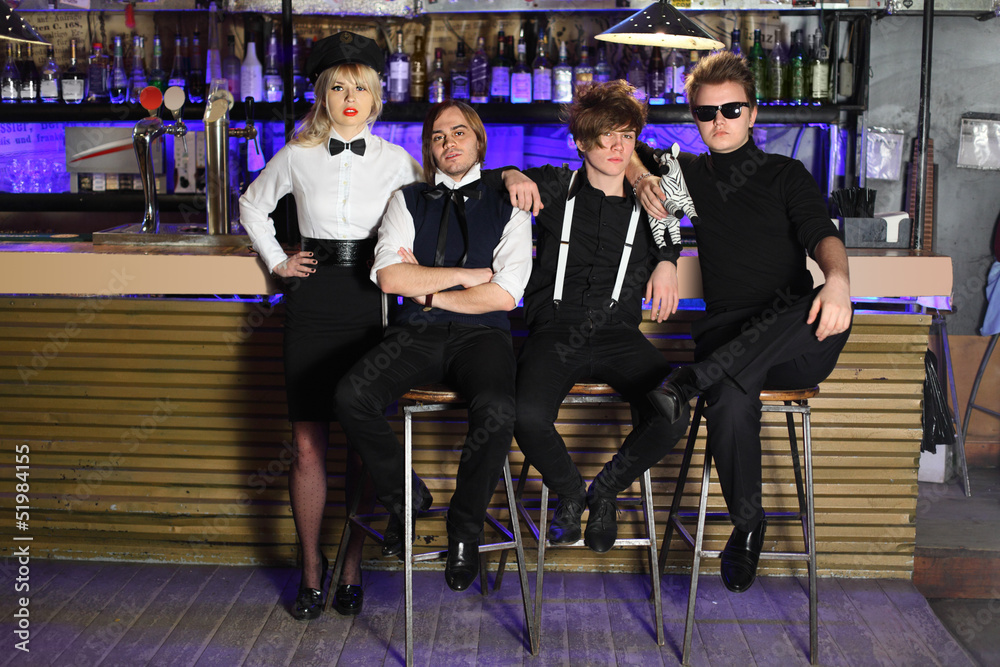 Four glamorous rock band pose near bar counter Stock Photo | Adobe Stock