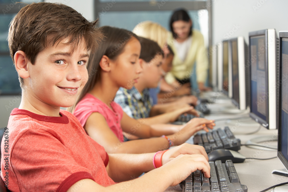 Elementary Students Working At Computers In Classroom Stock Photo ...