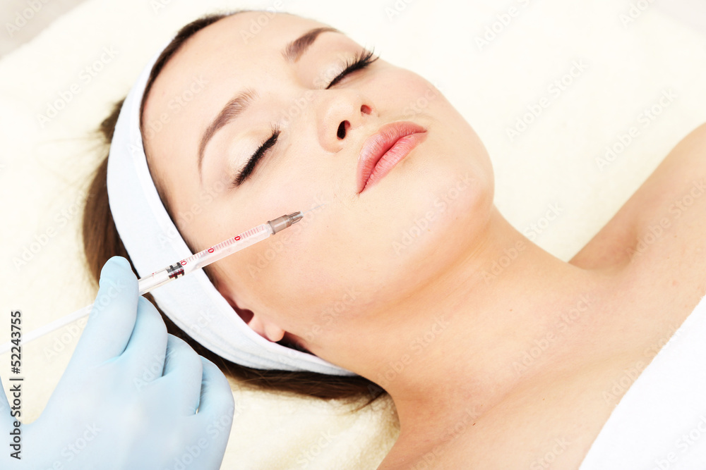 Young woman receiving plastic surgery injection Stock Photo | Adobe Stock