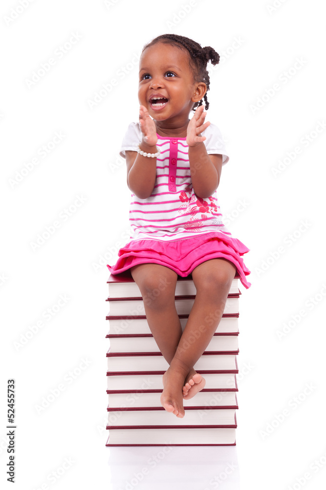 Cute black african american little girl seated in a stack of boo Stock ...