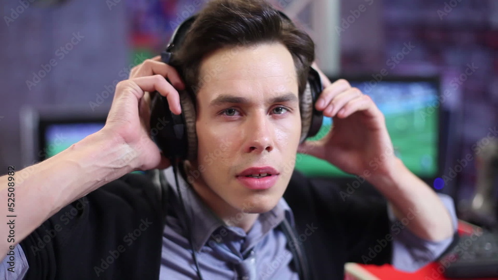 Amazed soccer commentator takes headphones off Stock Video | Adobe Stock