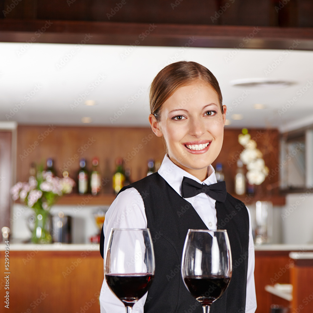 Kellnerin serviert Rotwein im Restaurant Stock Photo | Adobe Stock