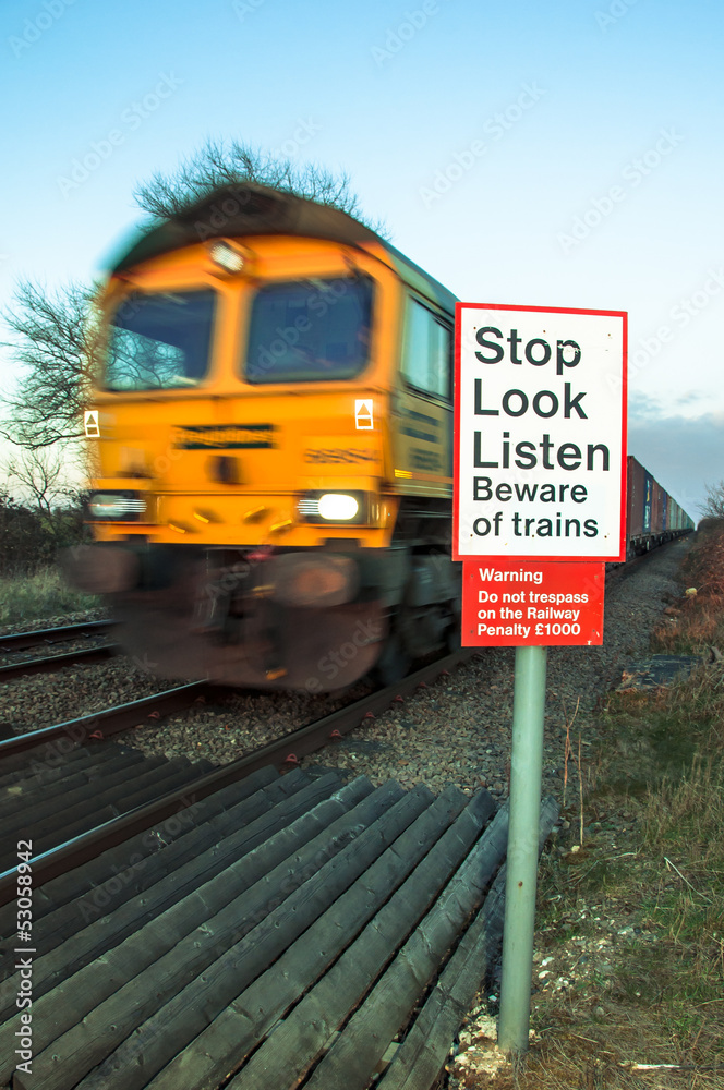 Beware of trains concept image with moving train in background Stock ...