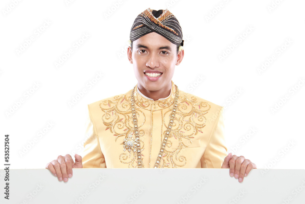 man wearing traditional dress of java holding blank board Stock Photo ...