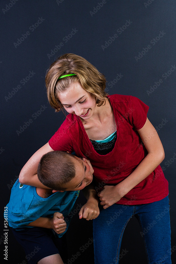 girl with boy in a headlock Stock Photo | Adobe Stock