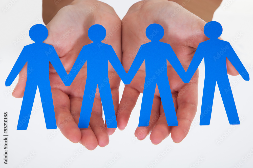 Male Hand Holding Human Figure Cutout Stock Photo | Adobe Stock