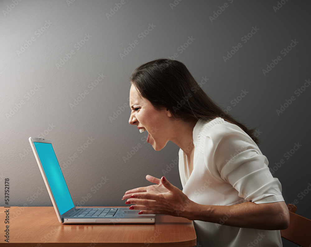 angry woman with laptop Stock Photo | Adobe Stock
