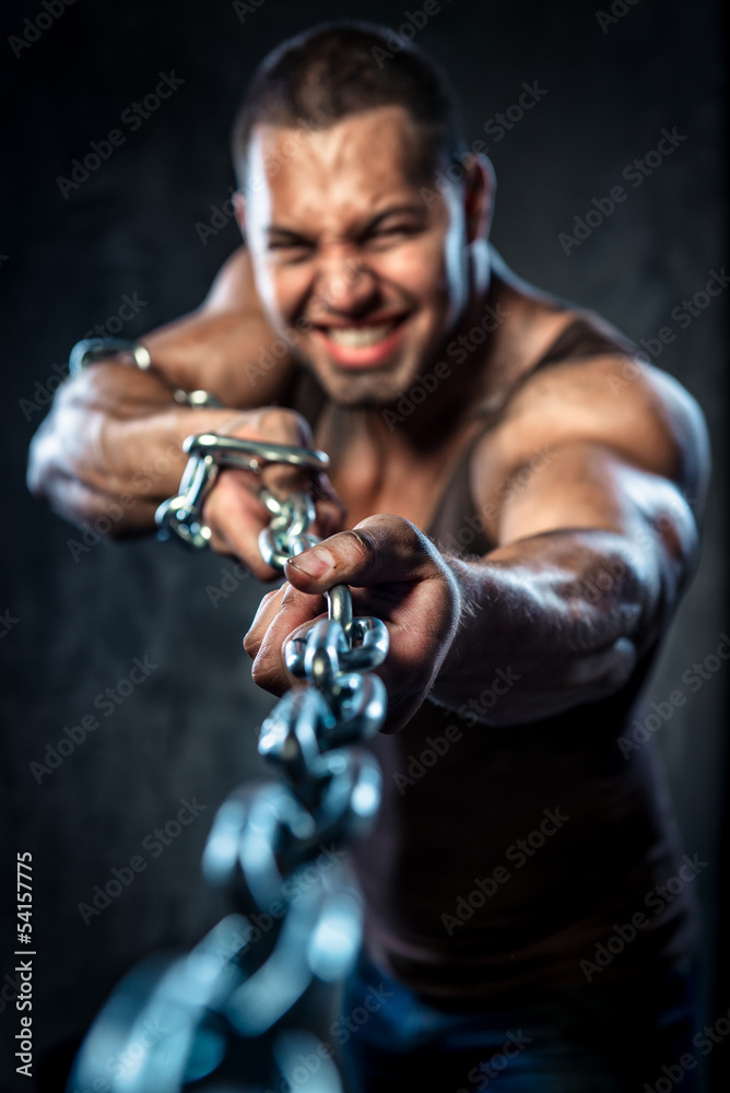 Muscular man pulling the chain Stock Photo | Adobe Stock