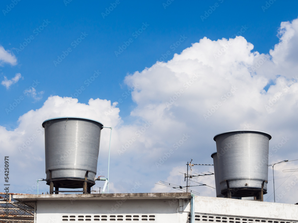 Rooftop water tanks on apartment building Stock Photo | Adobe Stock