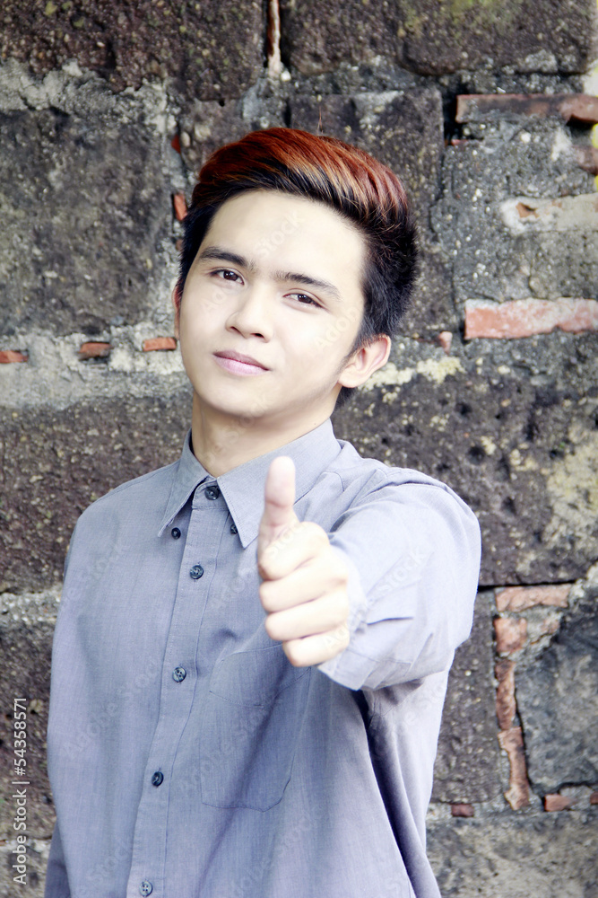 Filipino man making a thumbs up sign Stock Photo | Adobe Stock