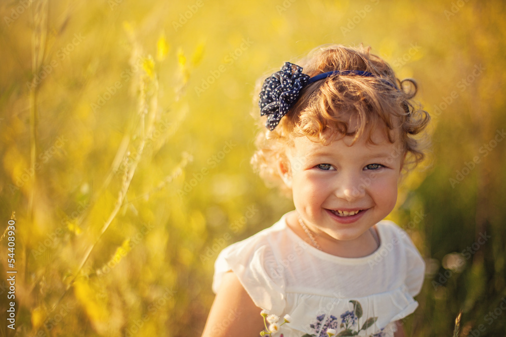 Smiling little girl on the field Stock Photo | Adobe Stock