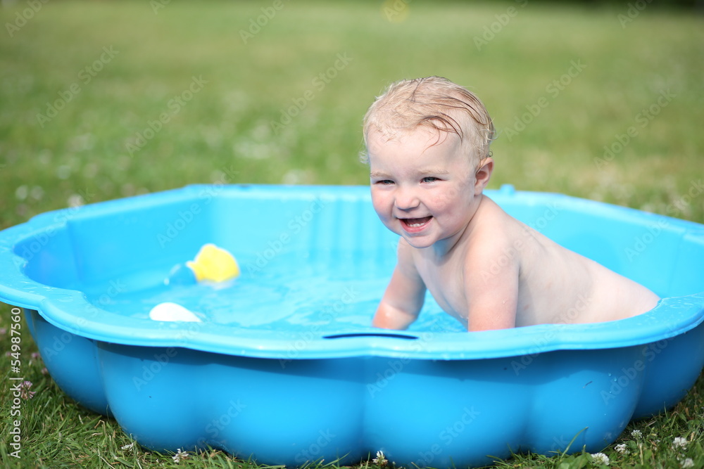 Adorable little girl having fun in a small kiddie pool Stock Photo ...