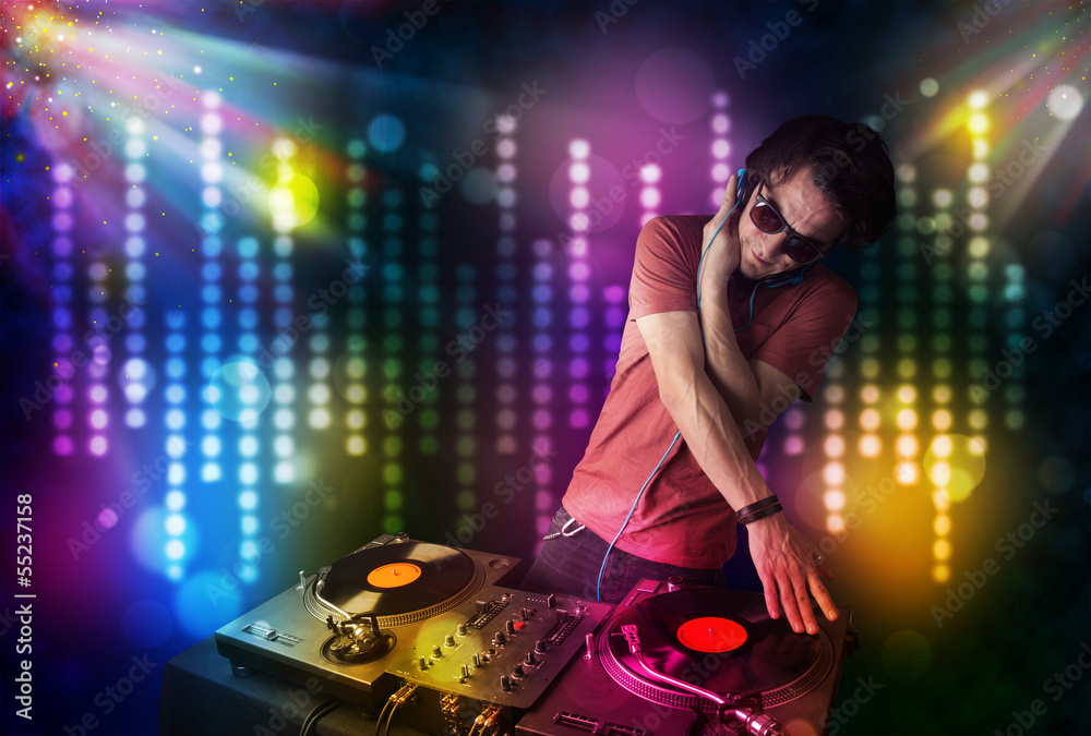 Dj playing songs in a disco with light show Stock Photo | Adobe Stock