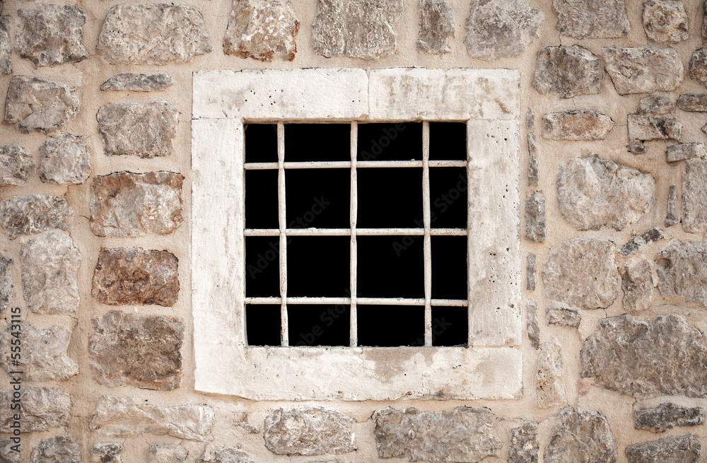 Ancient stone prison wall with metal window bars Stock Photo | Adobe Stock