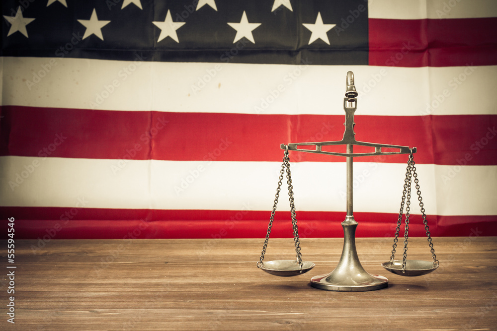Law scales on table front of USA flag. Symbol of justice Stock Photo ...