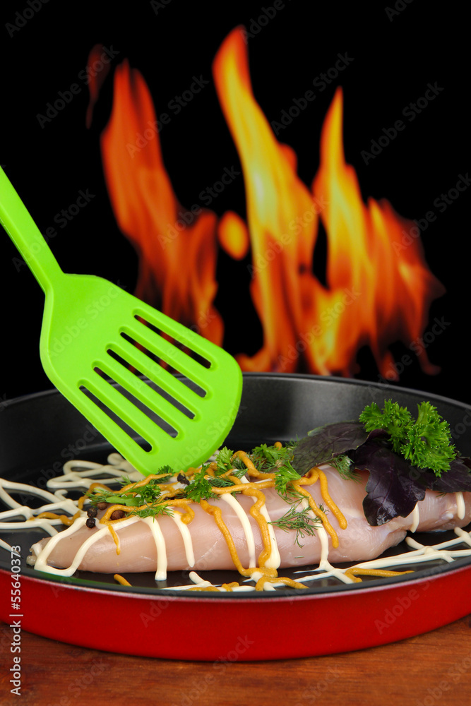 Raw chicken fillets on dripping pan, on fire background Stock Photo ...