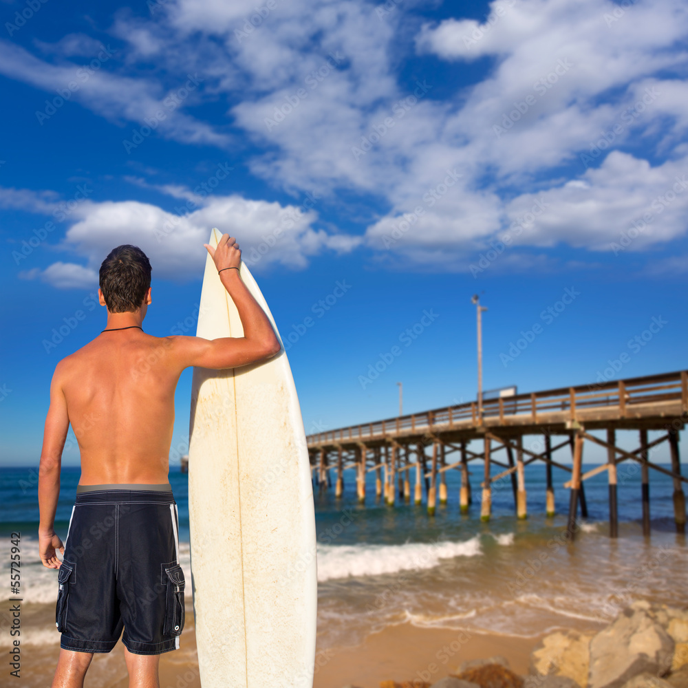 Boy surfer back view holding surfboard on beach Stock Photo | Adobe Stock