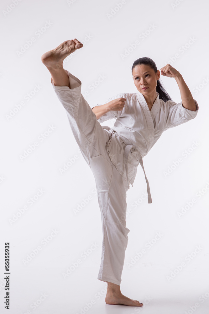 Beautiful asian woman makes kick in kimono on white Stock Photo | Adobe ...