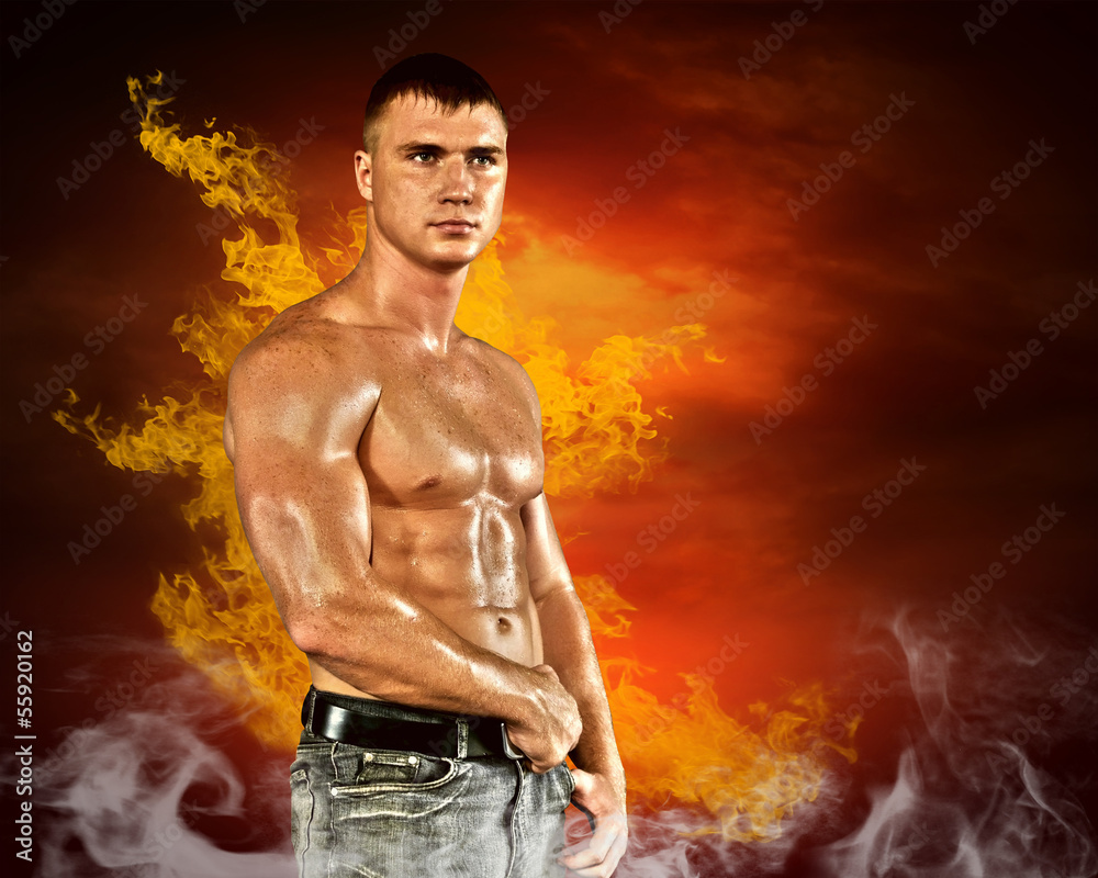 Bodybuilder posing on the fire flames background Stock Photo | Adobe Stock