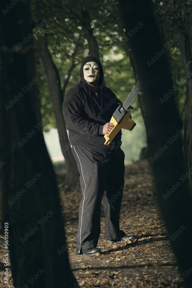 Creepy serial killer with chainsaw Stock Photo | Adobe Stock