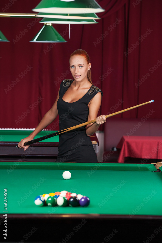 Sexy pool player. Beautiful young female pool player in black dr Stock Photo | Adobe Stock