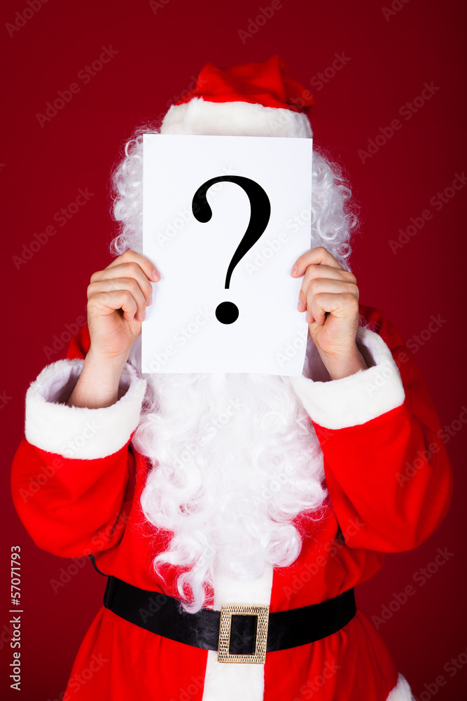 Santa holding question mark in front of his face Stock Photo | Adobe Stock