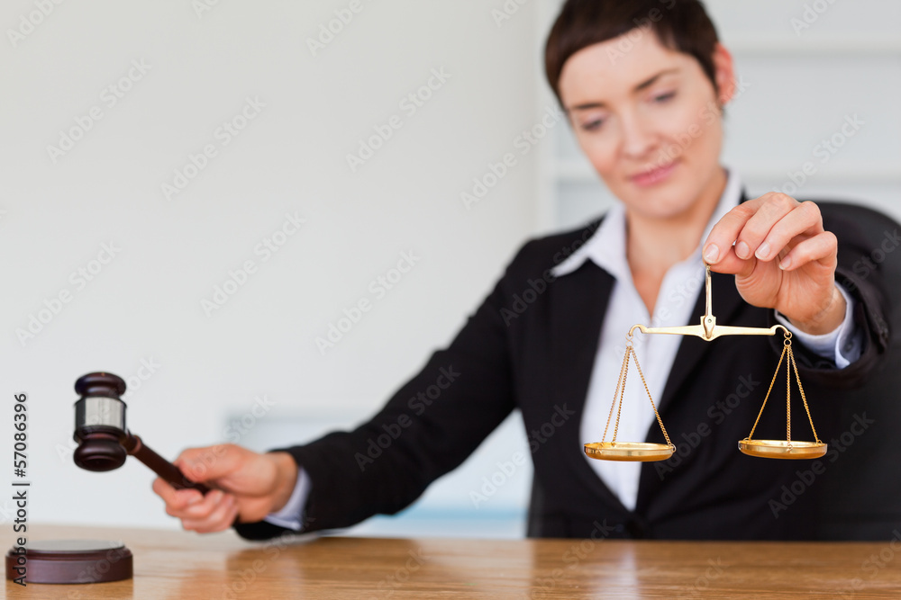 Serious judge with a gavel and the justice scale Stock Photo | Adobe Stock