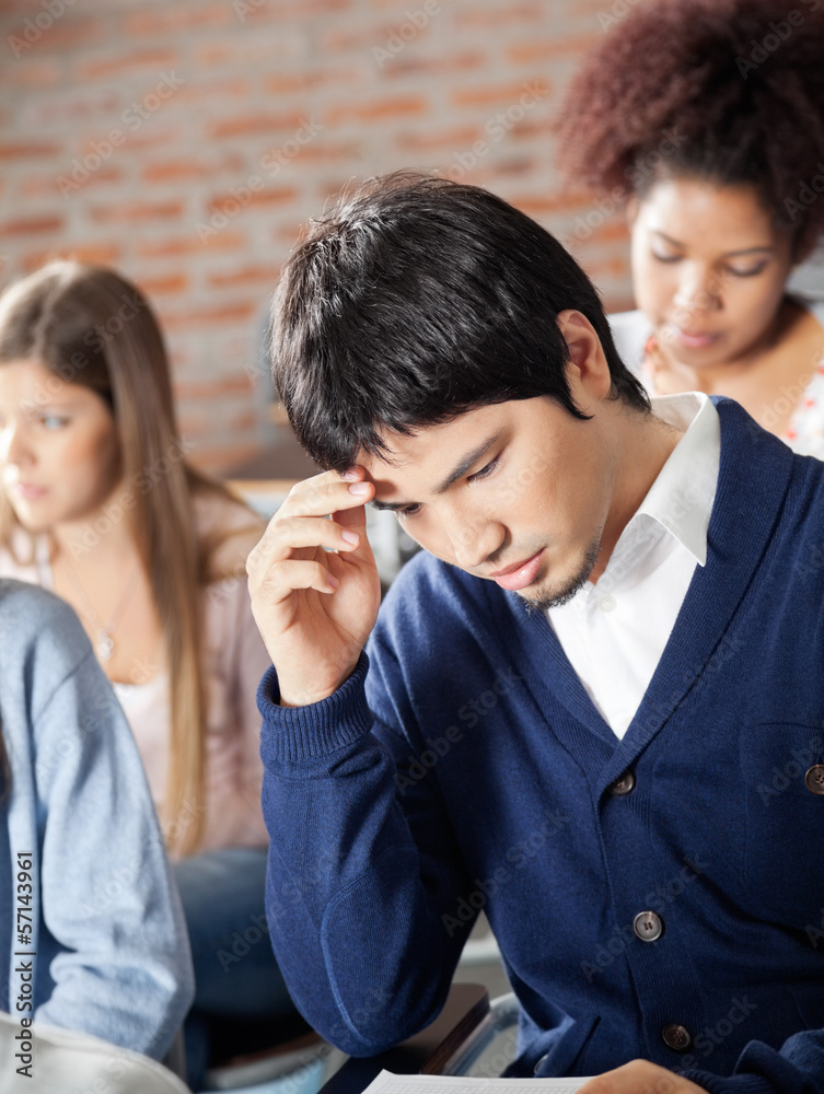Student Thinking With Classmates In Classroom Stock Photo | Adobe Stock