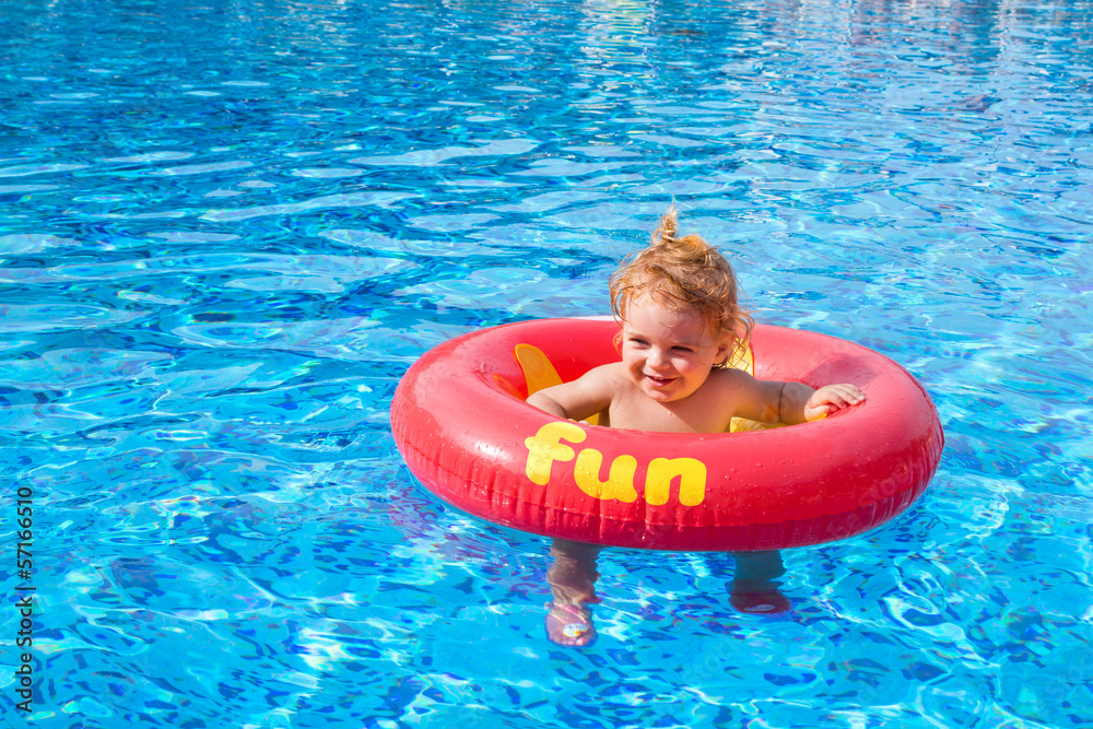 Beautiful little girl whit donut float in the pool - fun Stock Photo ...