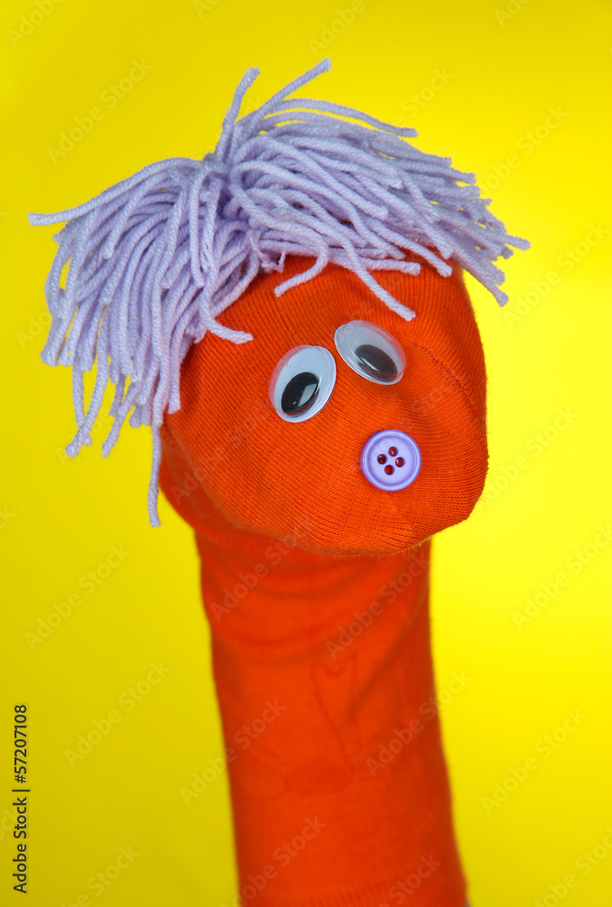 Cute sock puppet on yellow background Stock Photo | Adobe Stock