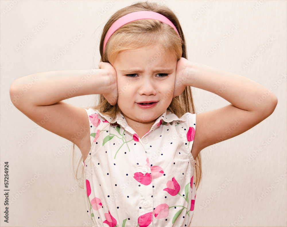 Little girl covering her ears Stock Photo | Adobe Stock