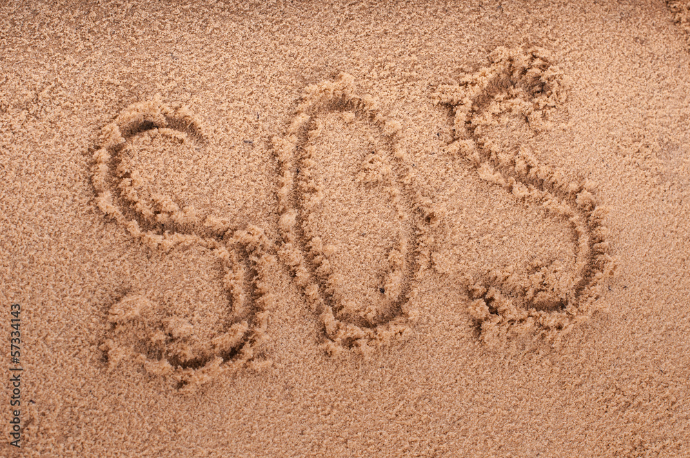 SOS on the beach sand at the sea. Stock Photo | Adobe Stock